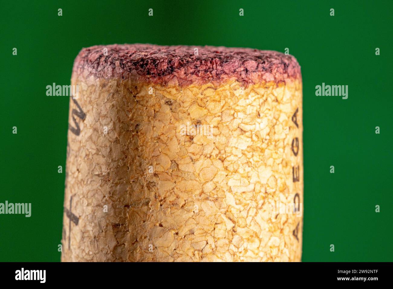 detail of a cork stopper used in a bottle of red wine with a ruby mark ...