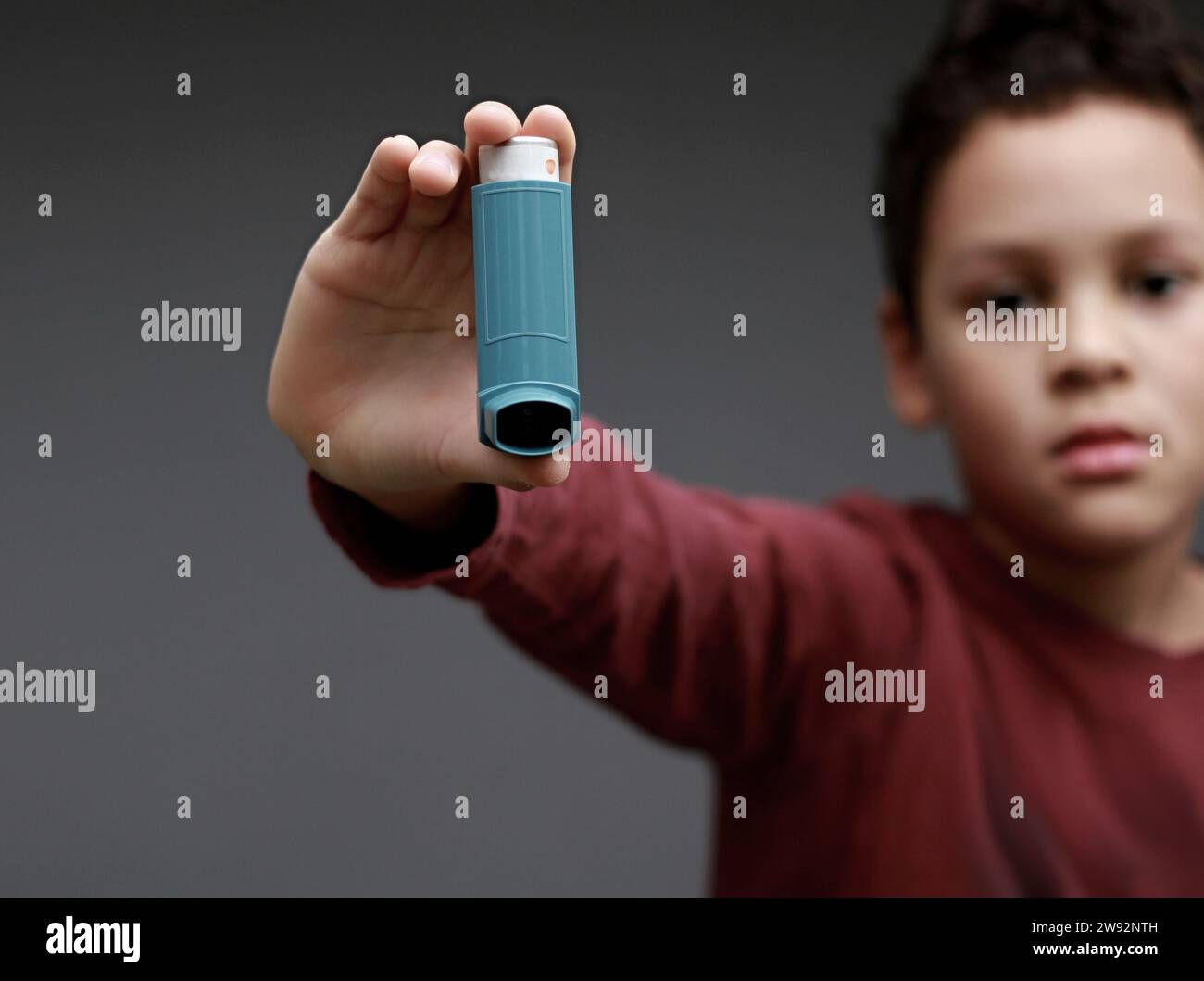 child with flu and inhaler respiratory puff on grey background with ...