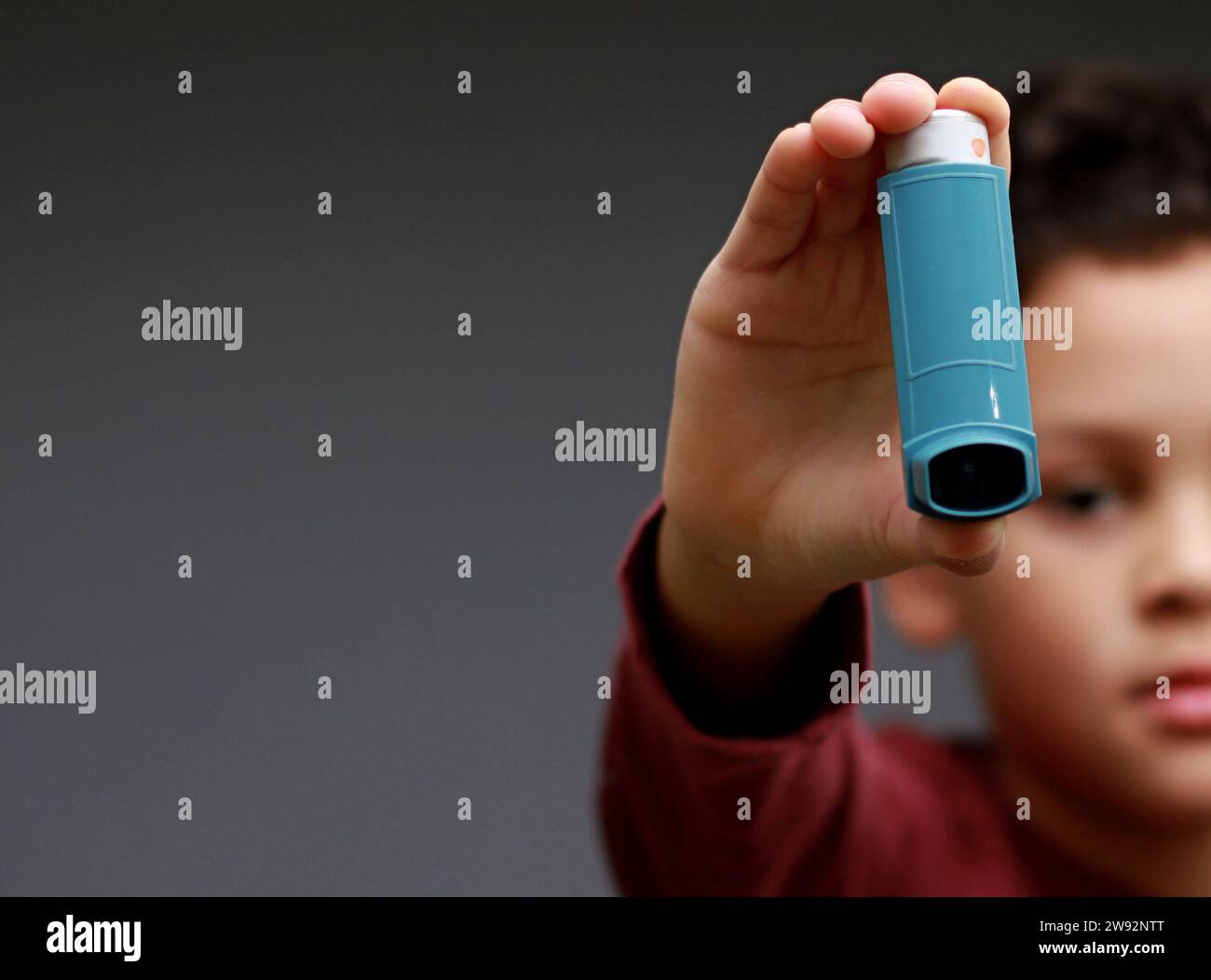 child with flu and inhaler respiratory puff on grey background with ...