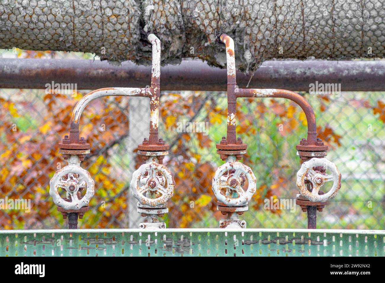 4 old and rusty faucets lined up in a chemical factory Stock Photo - Alamy