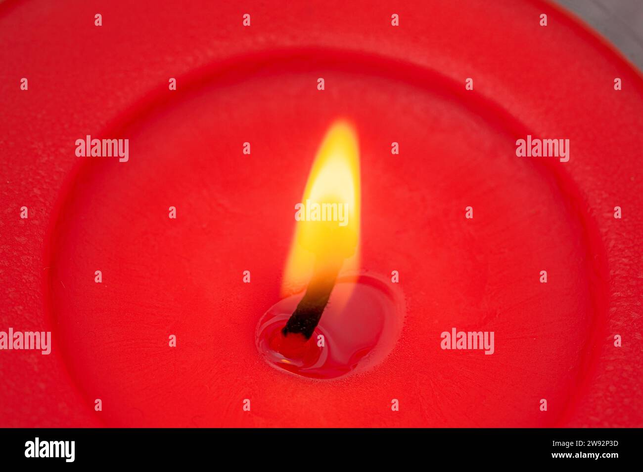 red wax candle with burning flame Stock Photo - Alamy