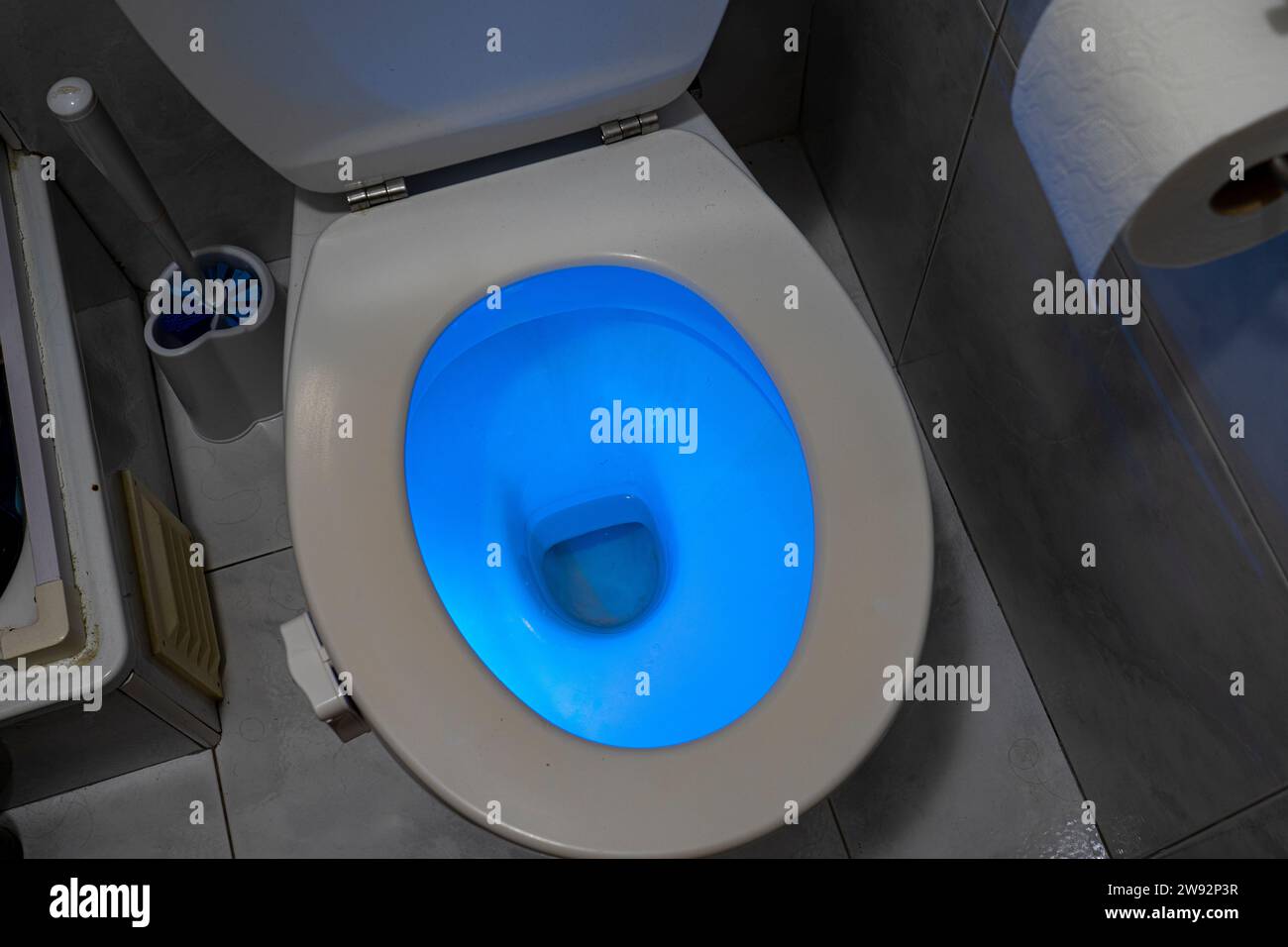 toilet illuminated with blue light inside by means of a device ...