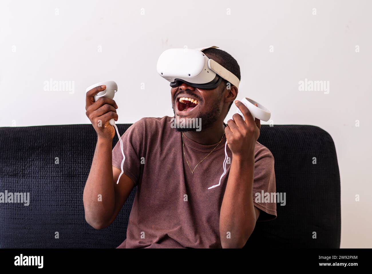 Black man holding a game controller hi-res stock photography and images ...