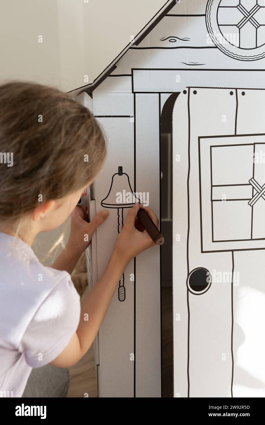 the child draws with a felt-tip pen. drawing lessons, a girl in the ...