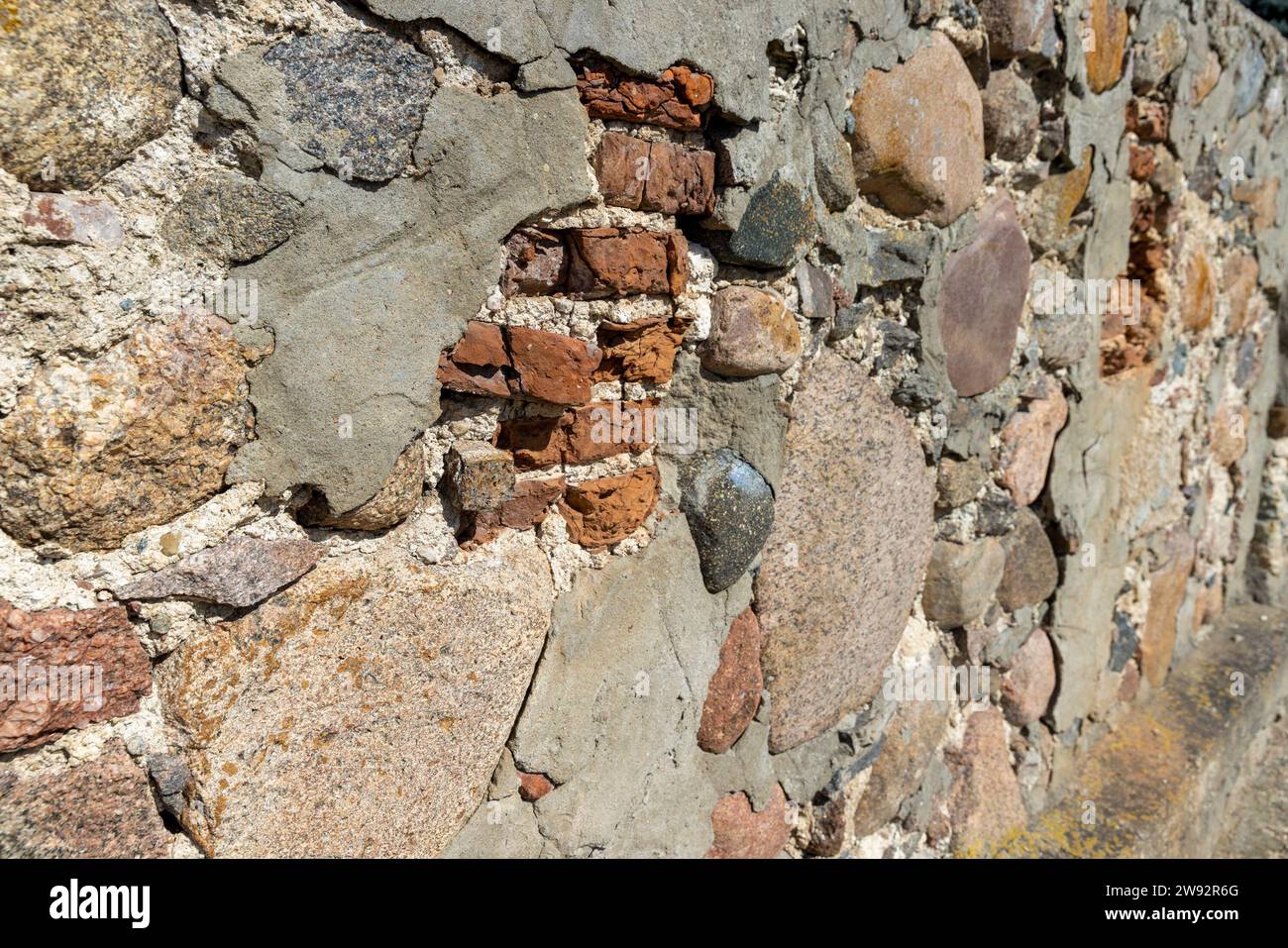 ancient wall of cobblestones and red bricks, combined ancient wall of ...