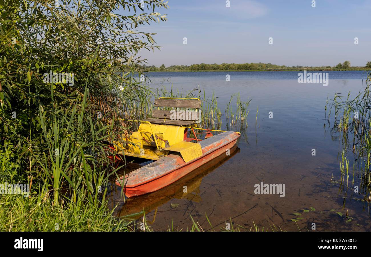 old catamaran on the lake shore, one old catamaran for walking on the ...