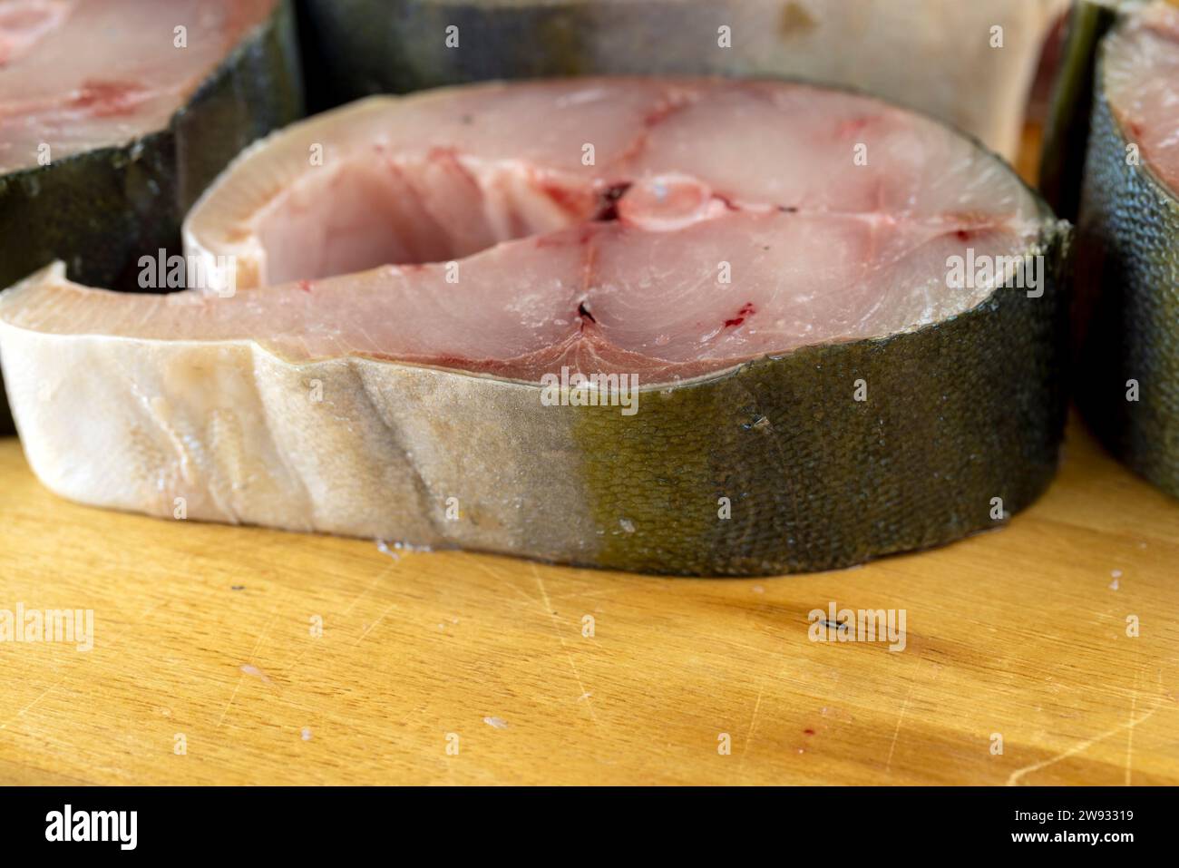 pieces of sea fish during cooking, raw yellow-tailed fish during ...