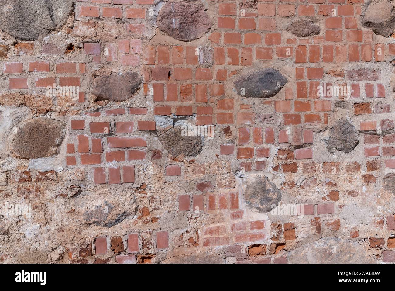 ancient wall of cobblestones and red bricks, combined ancient wall of ...