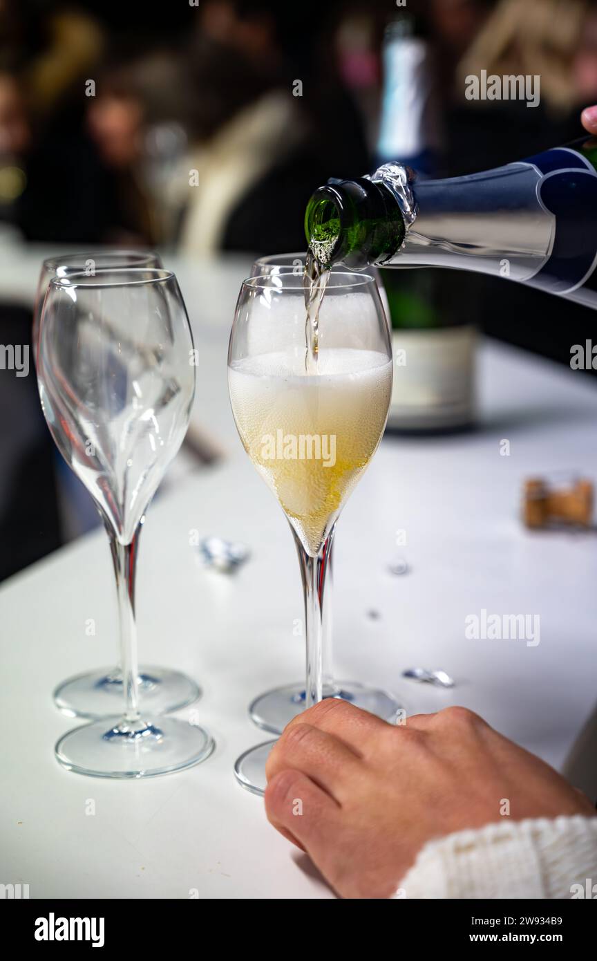 Visitors drinking of sparkling wine champagne on outdoor winter ...