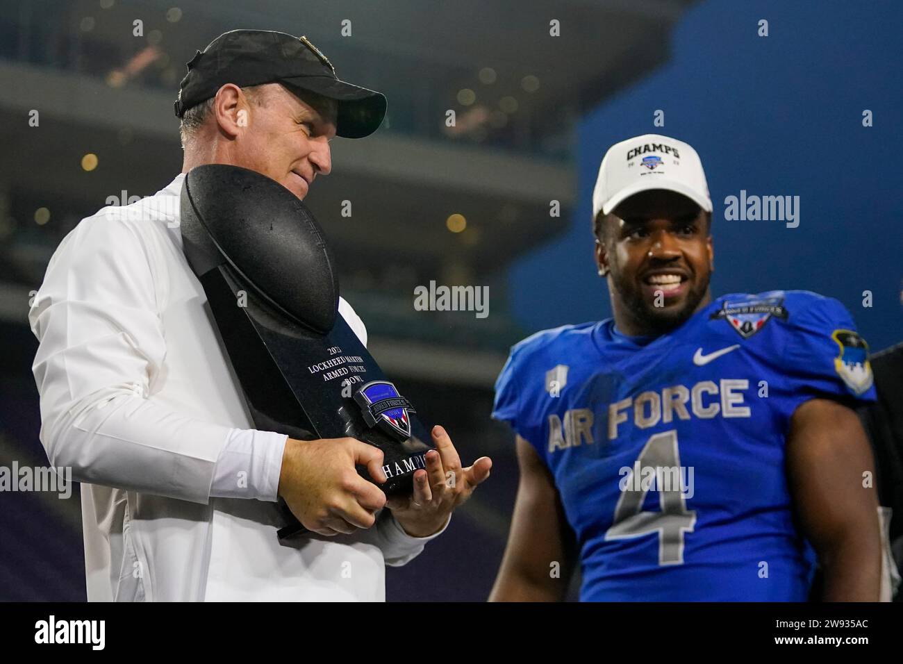 Air Force head coach Troy Calhoun, left, holds the Armed Forces Bowl ...