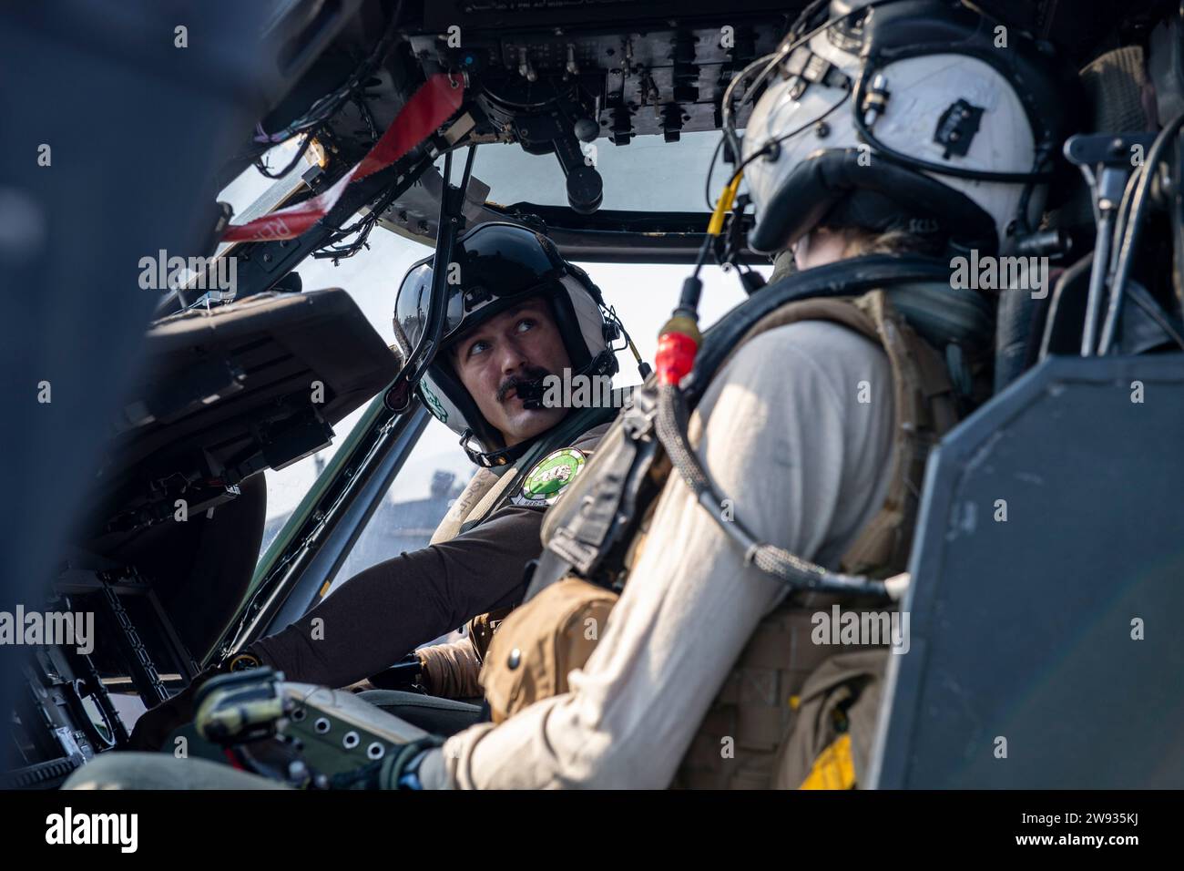 U.S. Navy Lt. Mac Burke conducts a pre-flight check on an MH-60S Sea ...