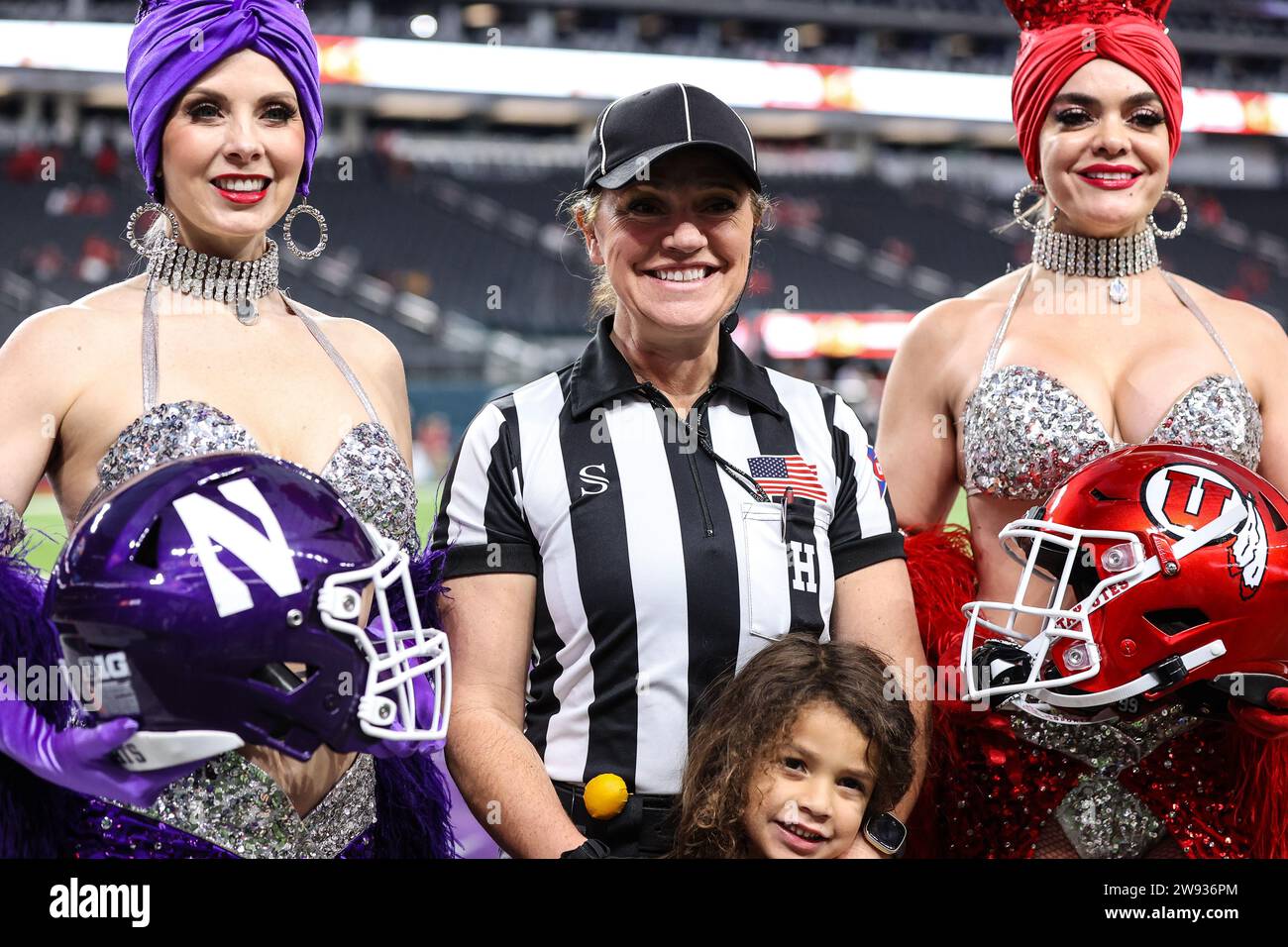 December 23, 2023: Head Line Judge Cat Conti poses with two Las Vegas ...