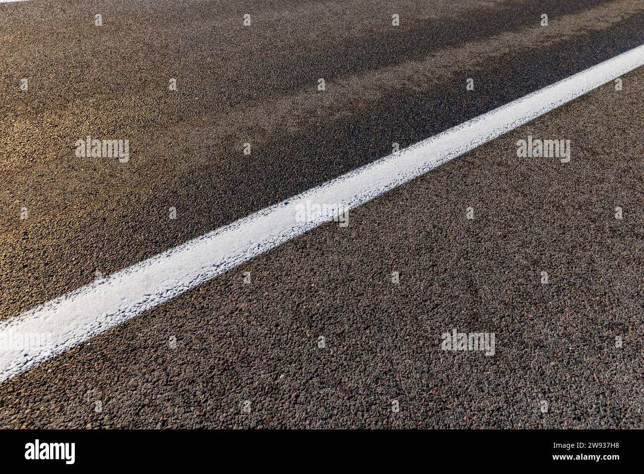 asphalting a new highway with black new asphalt, a close-up of a part ...