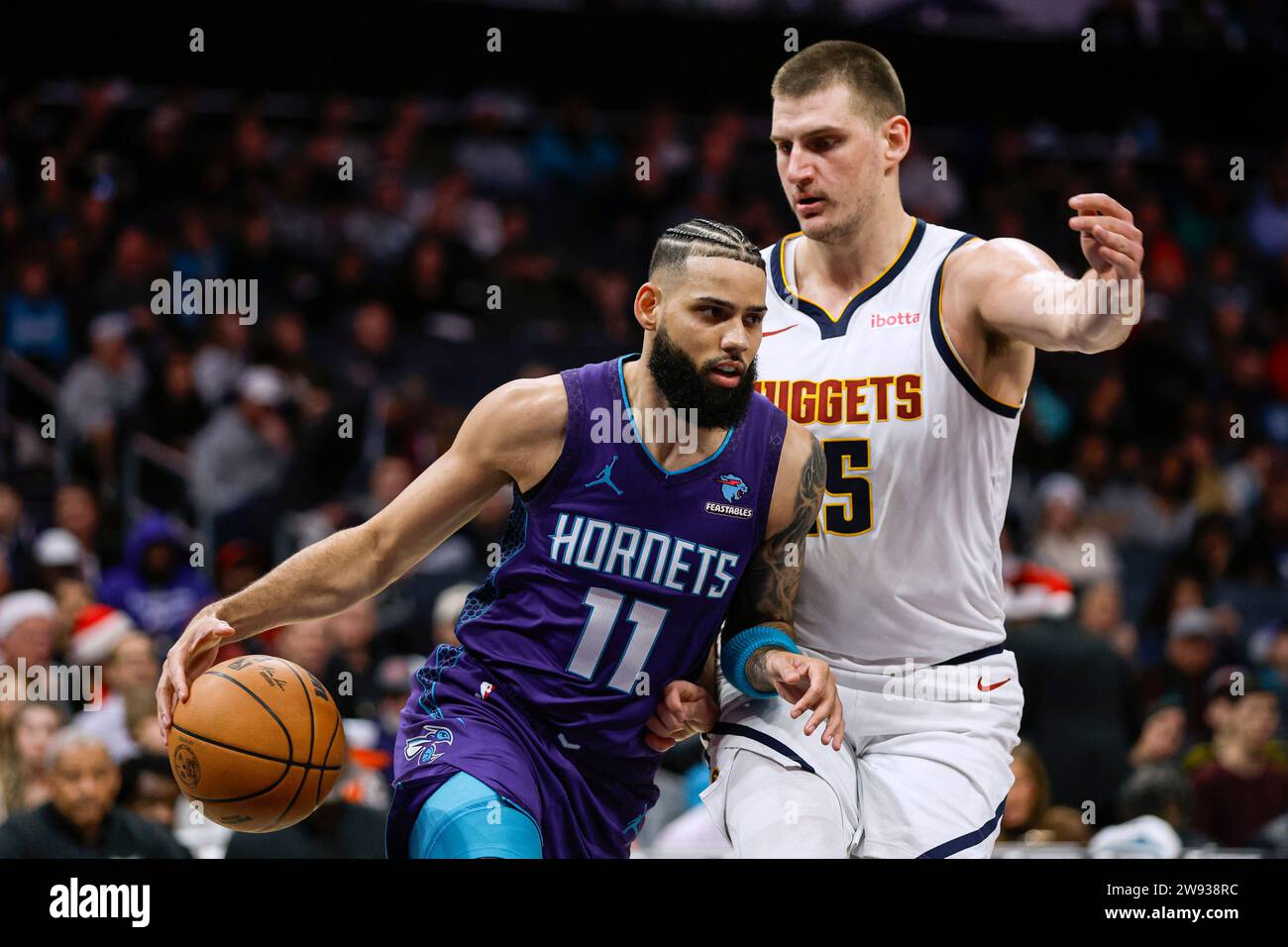 Charlotte Hornets forward Cody Martin (11) drives against Denver ...