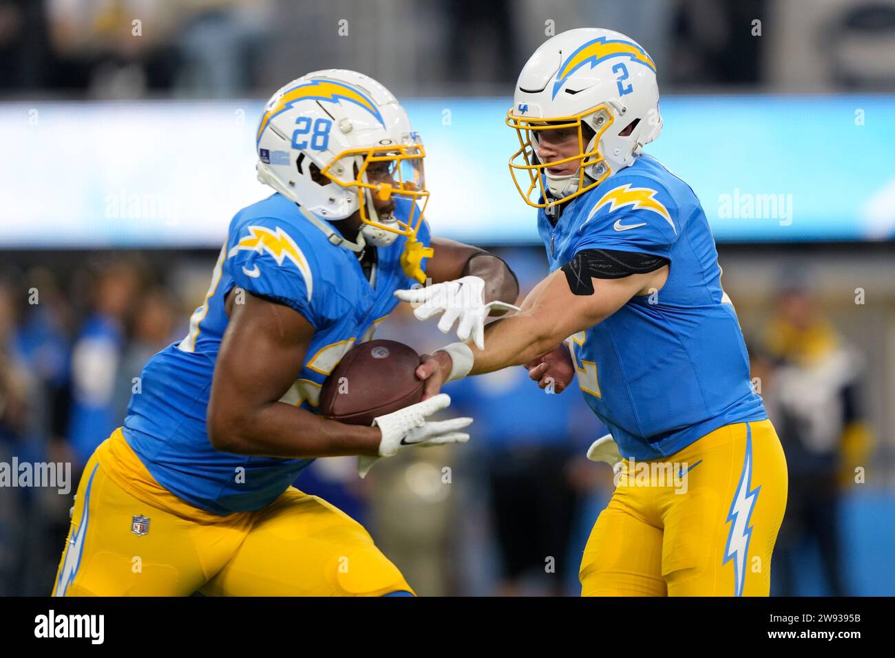 Los Angeles Chargers quarterback Easton Stick (2) hands off to running ...