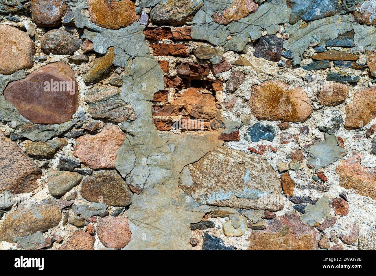 ancient wall of cobblestones and red bricks, combined ancient wall of ...