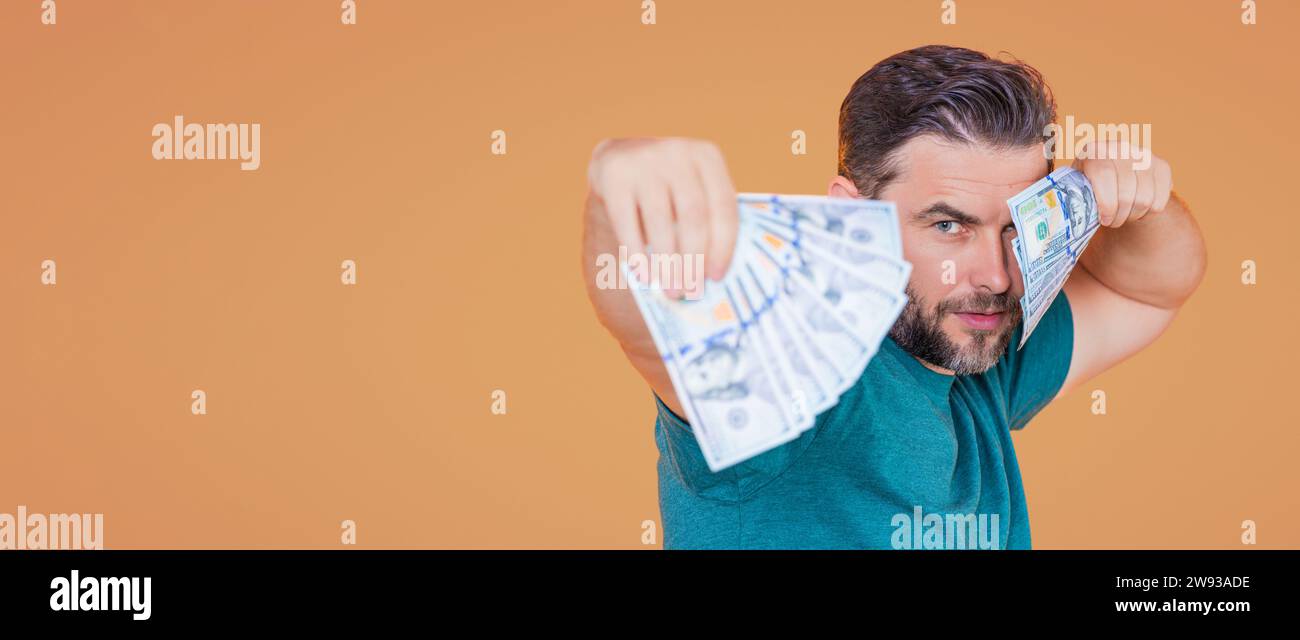 Man hold money on beige studio isolated banner background. Rich man in ...