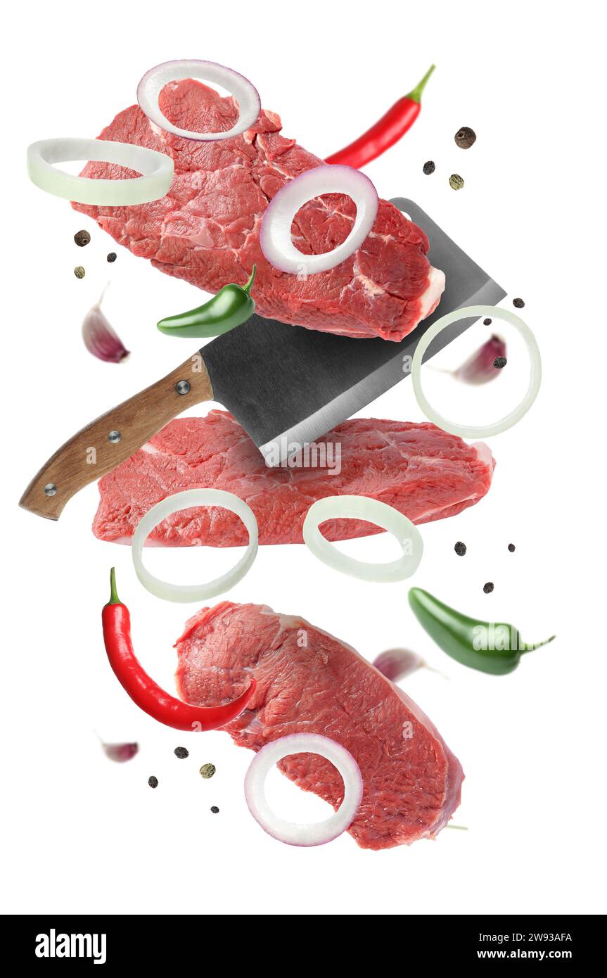 Beef meat, different spices and cleaver knife falling on white ...