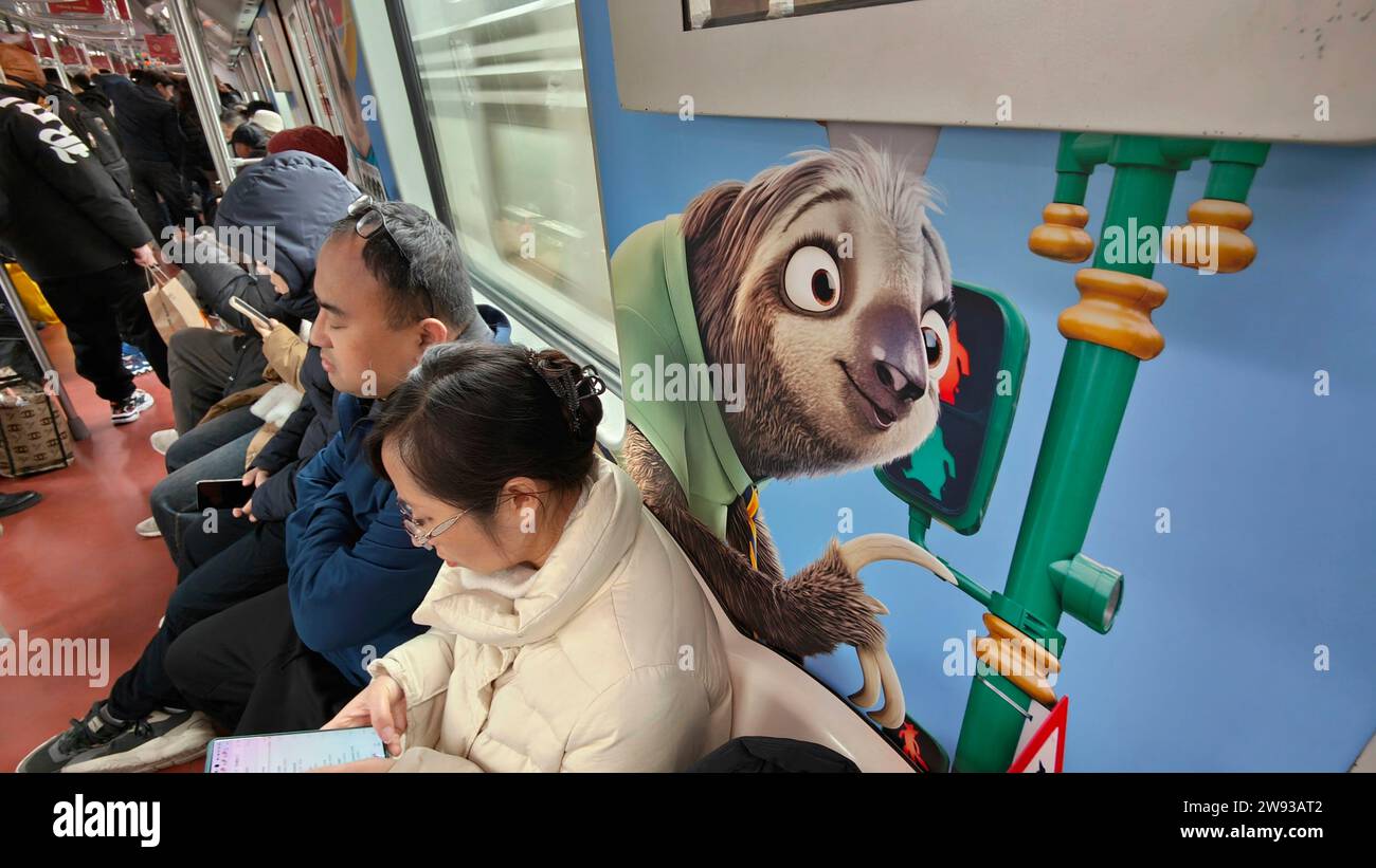 People ride a subway train decorated in the Zootopia theme on the ...