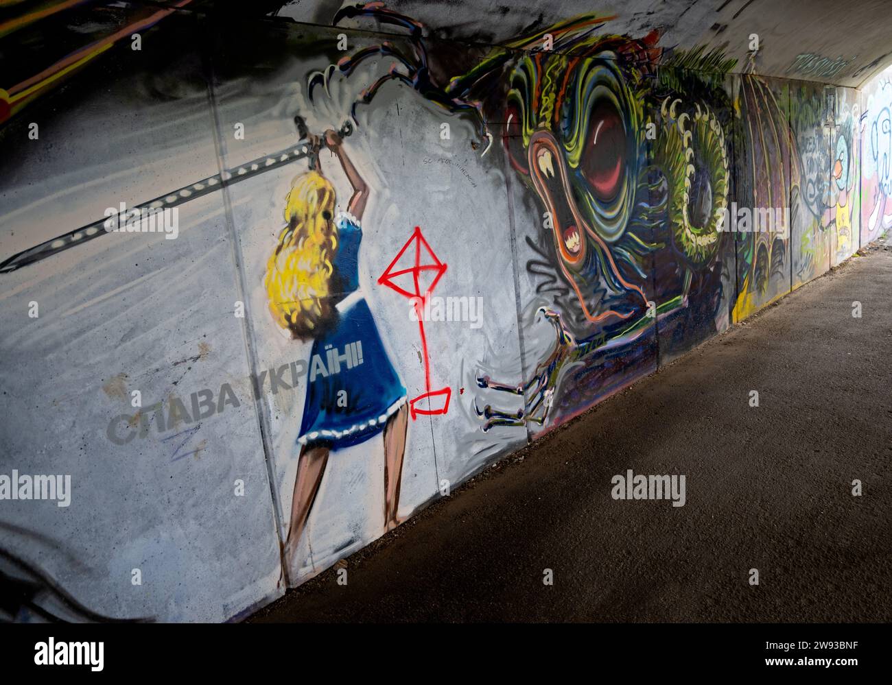 Girl in blue dress with sword attacking a monster: Graffiti under the ...