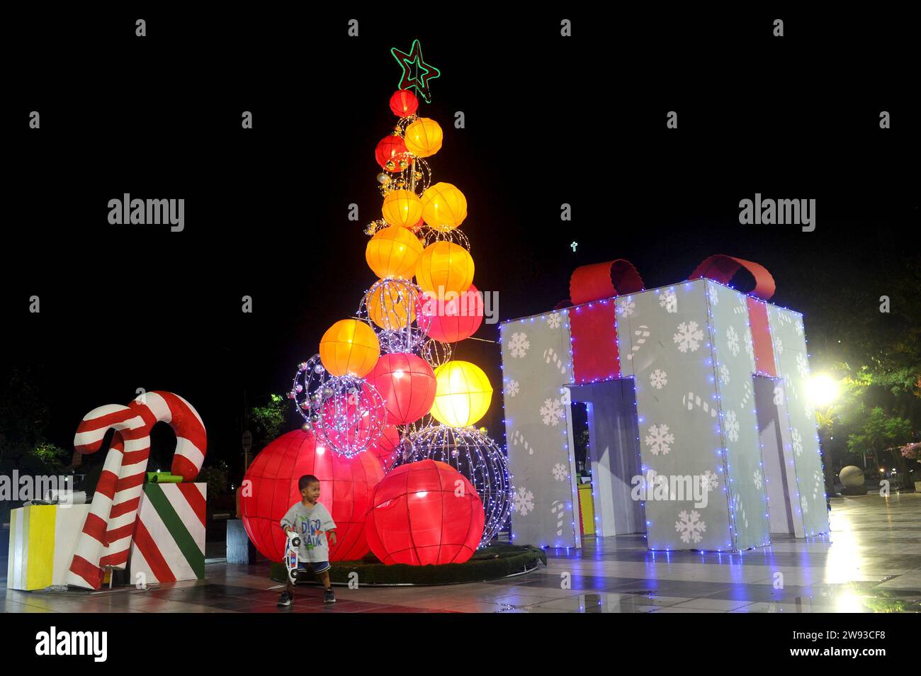 Surabaya, Indonesia. 23rd Dec, 2023. A boy has fun near Christmas light ...