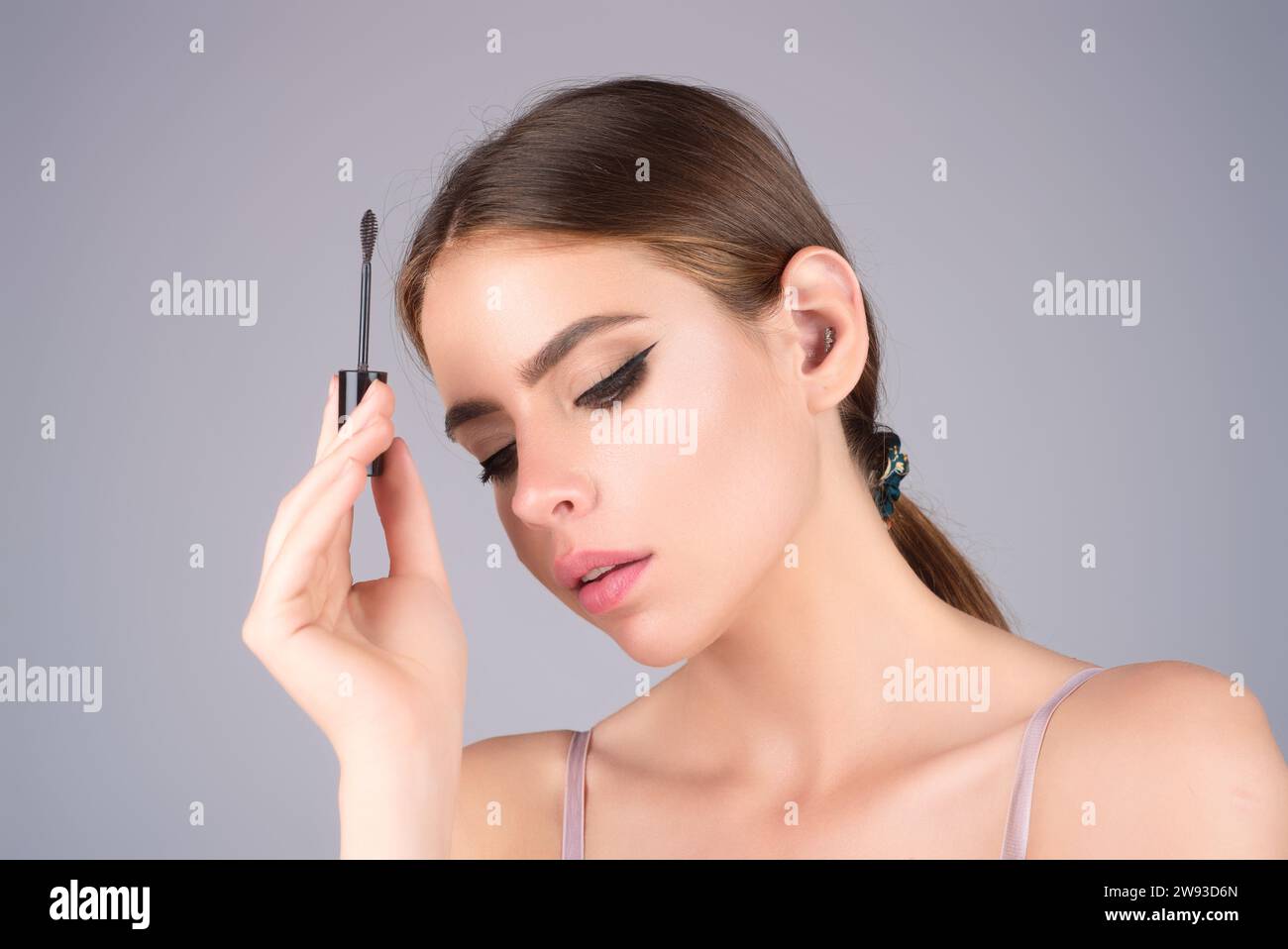 Eyebrow shaping, woman combs eyebrows with a brus. Eyebrow line. Makeup ...