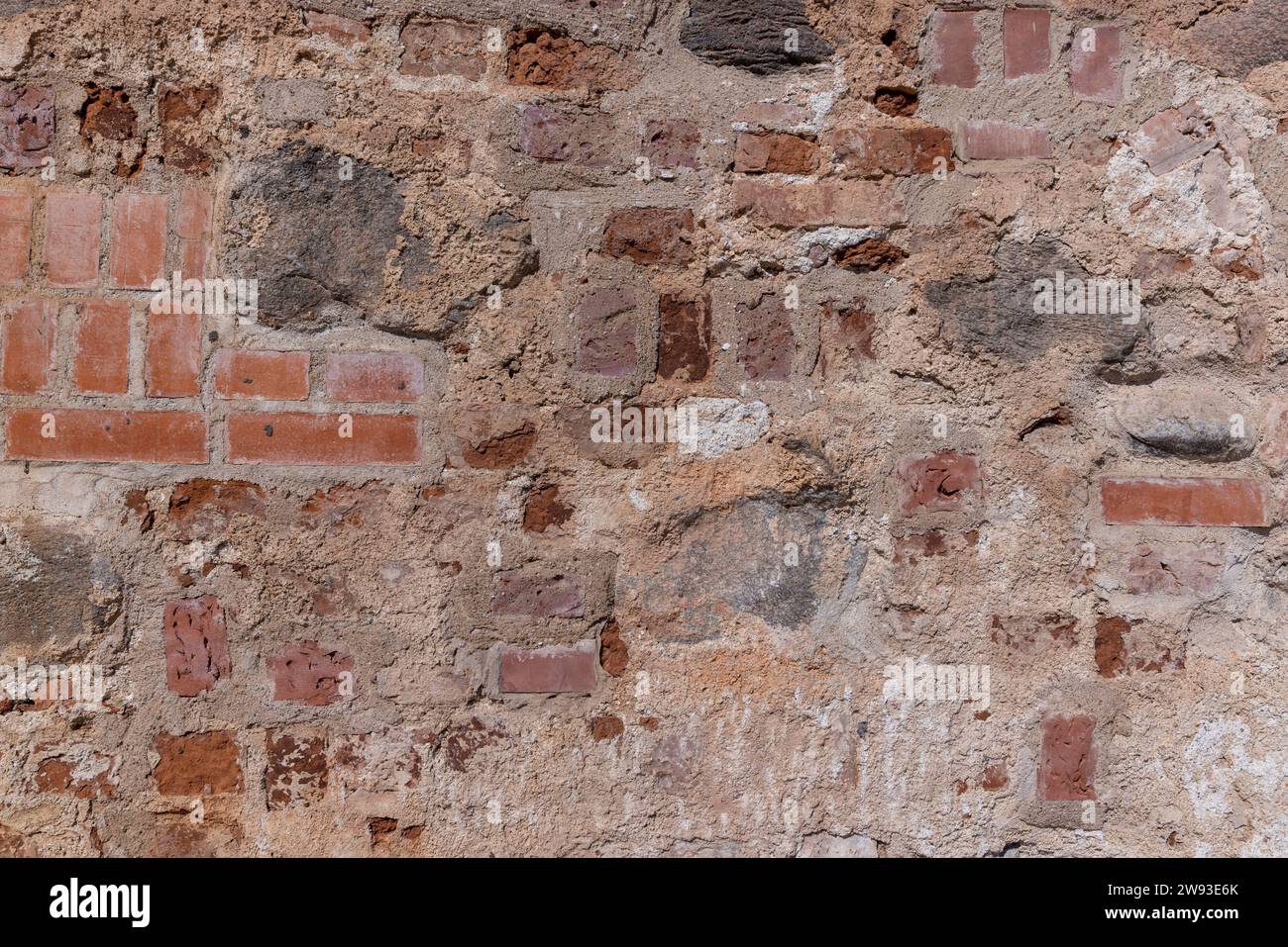 ancient wall of cobblestones and red bricks, combined ancient wall of ...