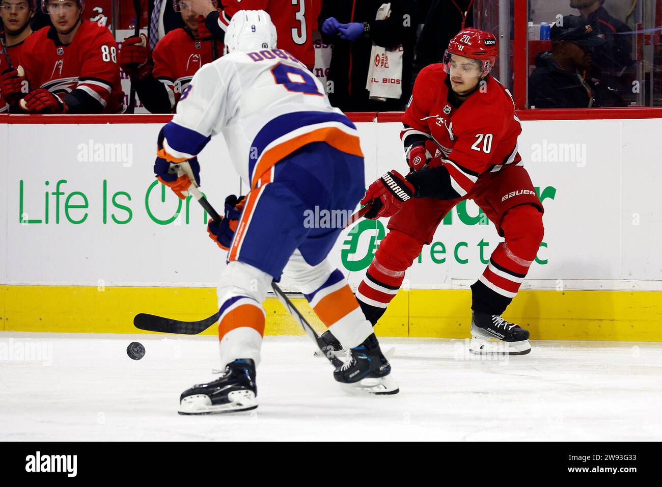 Carolina Hurricanes' Sebastian Aho (20) passes the puck past New York ...