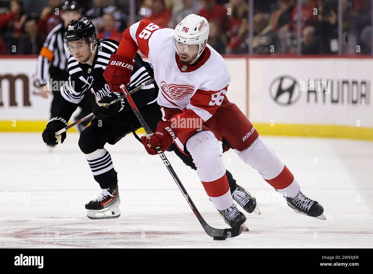 Detroit Red Wings defenseman Jake Walman (96) controls the puck past ...