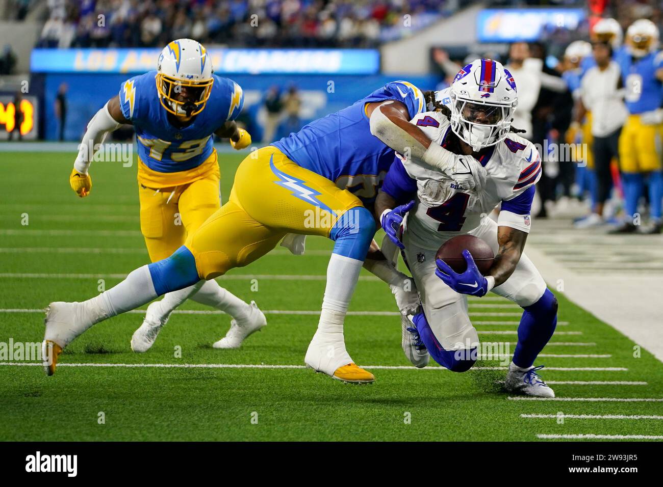 Buffalo Bills running back James Cook (4) is tackled by Los Angeles ...