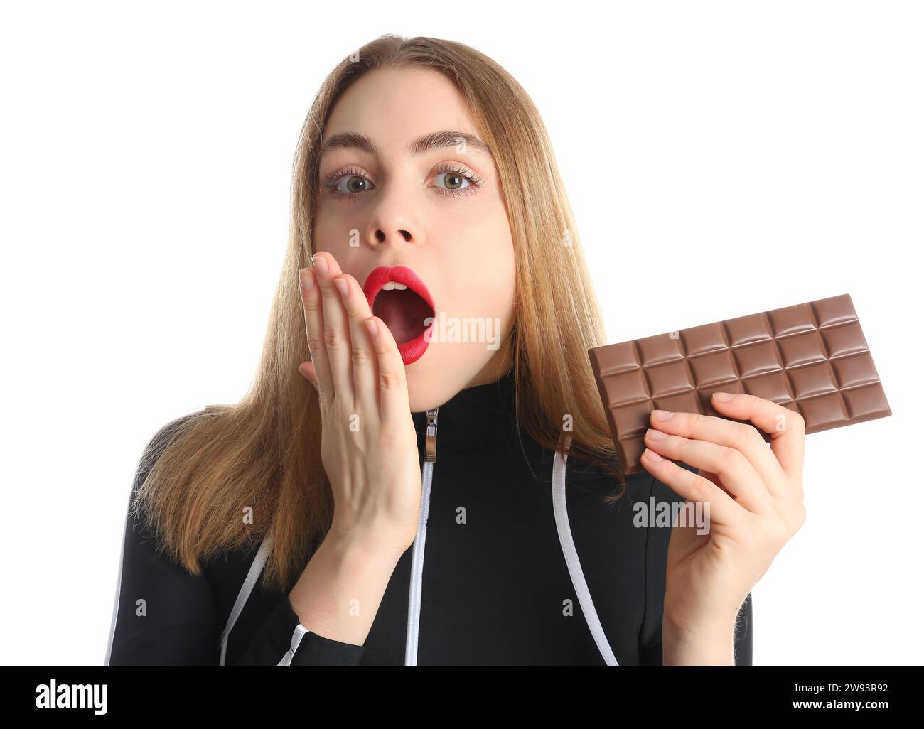 Shocked young woman with chocolate bar on white background Stock Photo ...