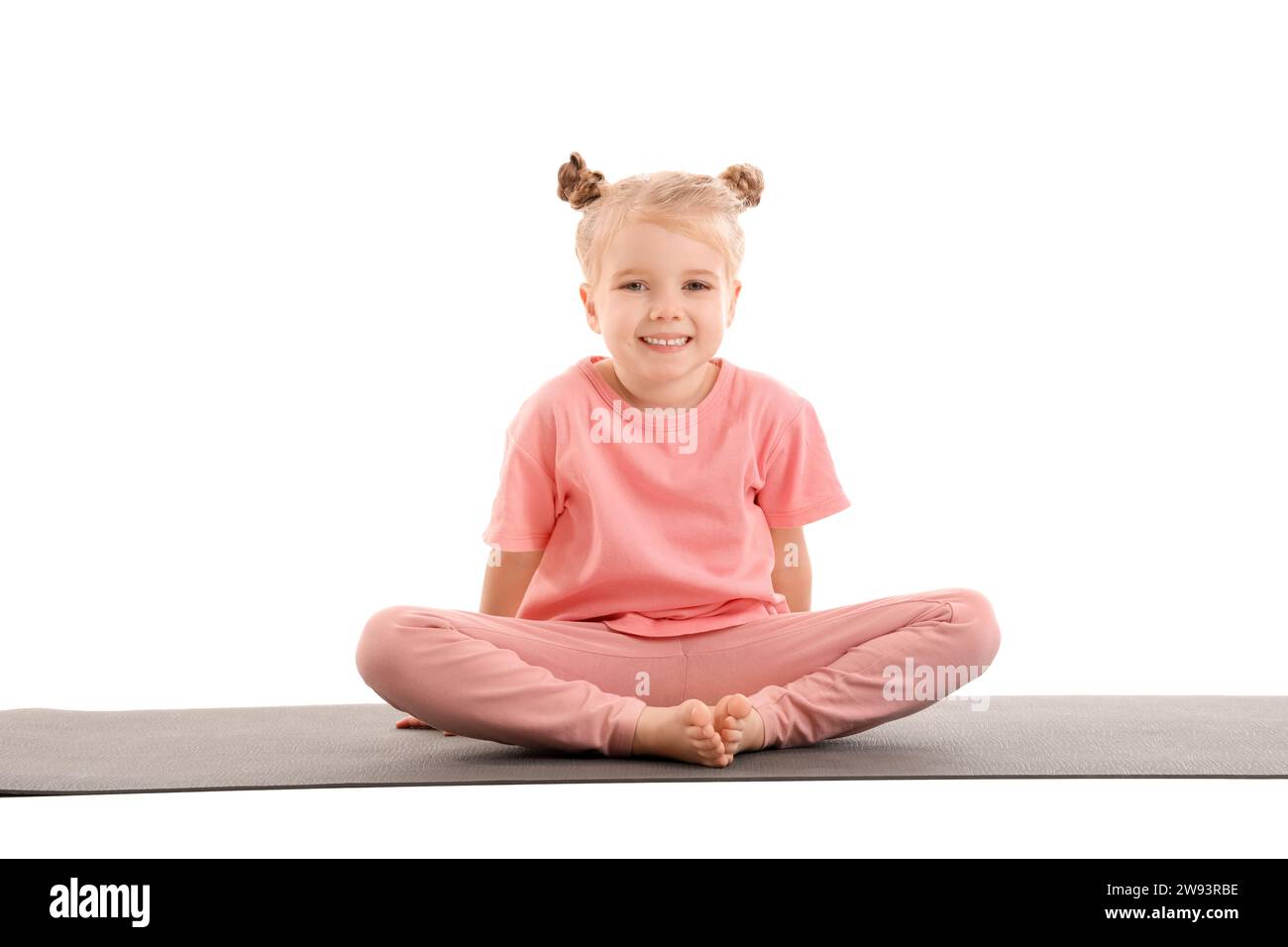 Cute little happy girl with mat practicing yoga isolated on white ...