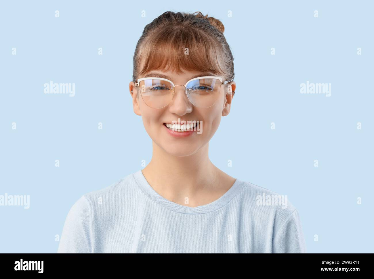 Young woman in eyeglasses on light background. Glaucoma awareness month ...