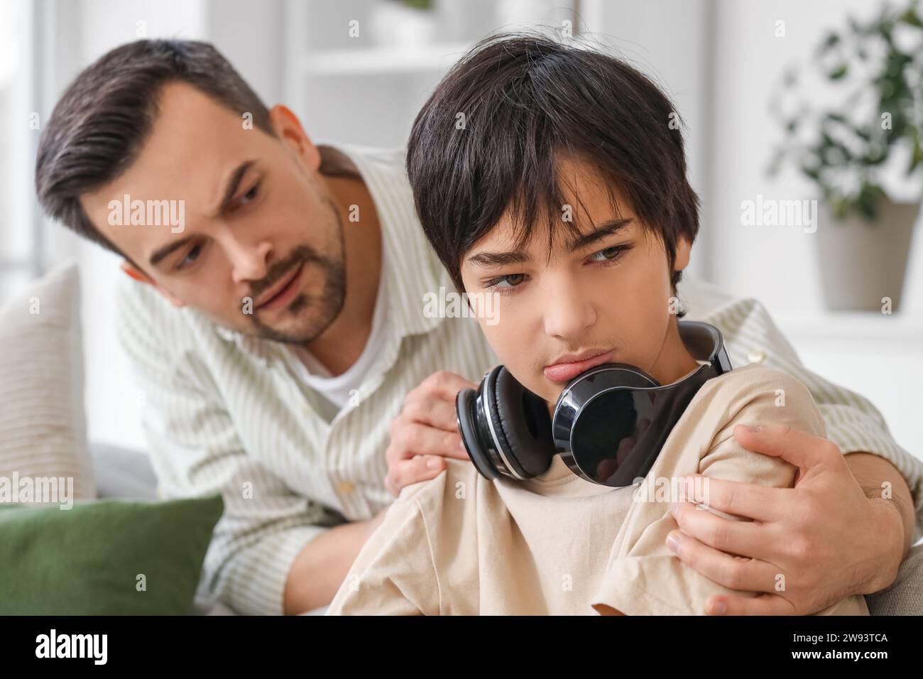Upset teenage boy with his father at home. Family problem concept Stock ...