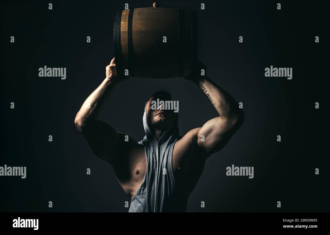 Strong man hold wooden barrel on black. Oktoberfest. Brewer man ...