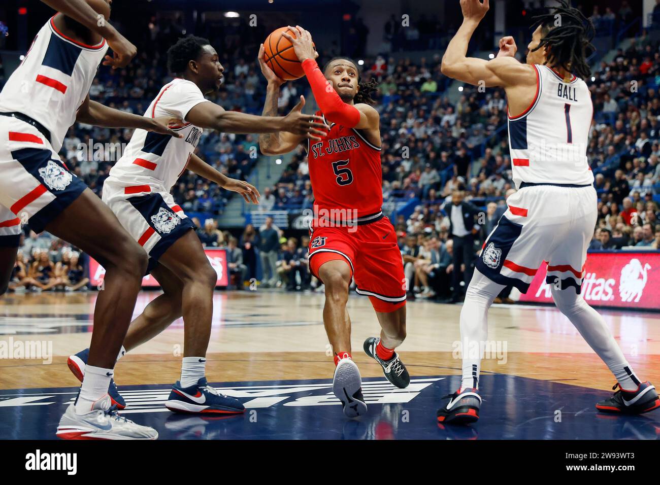 St. John's Daniss Jenkins (5) drives for the basket between UConn's ...