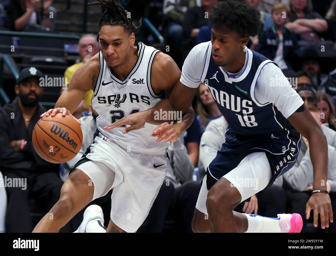 San Antonio Spurs guard Devin Vassell (24) tries to drive the ball past Dallas Mavericks forward ...