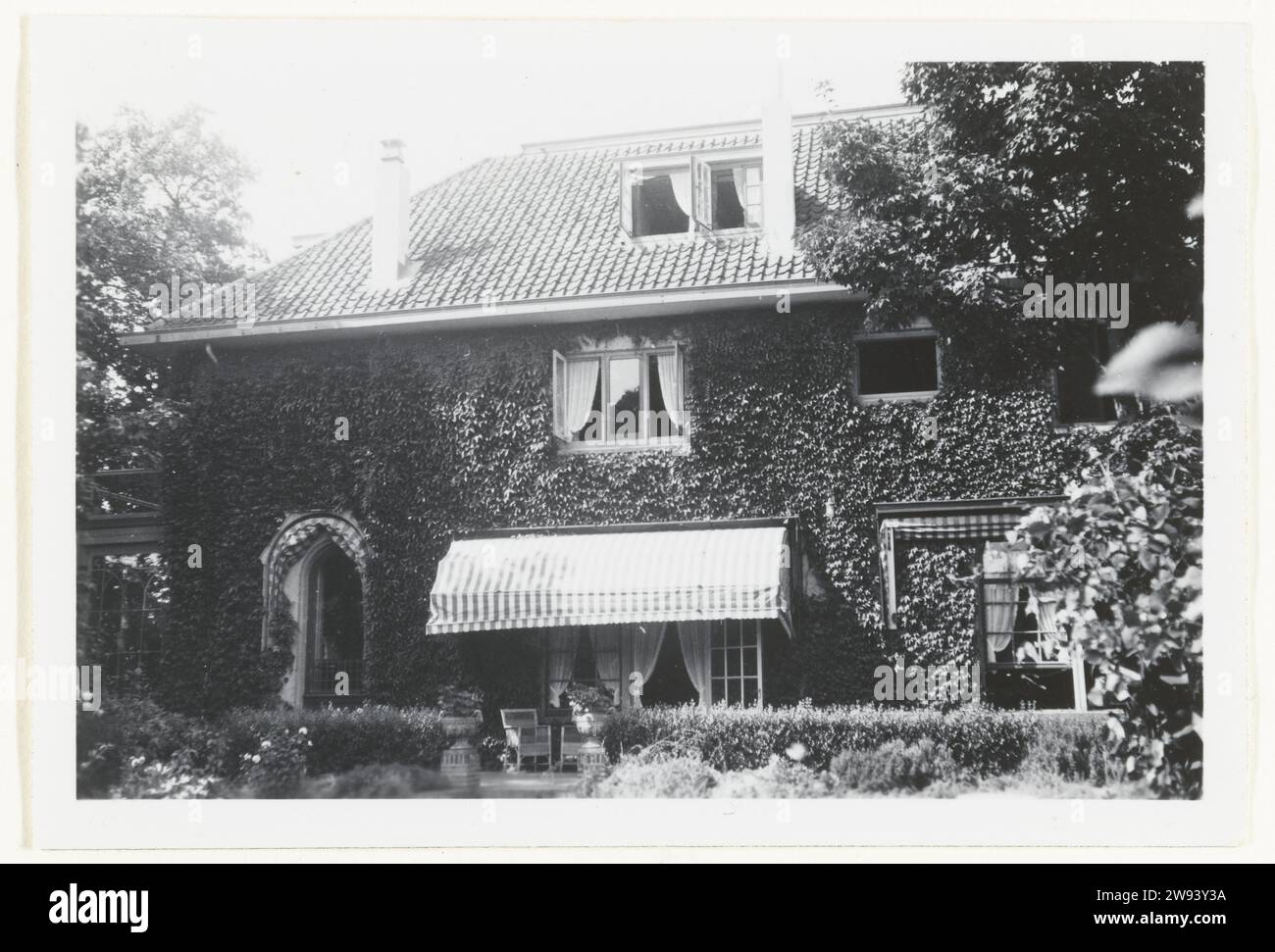 Villa, 1940 - 1942 photograph A villa with a overgrown facade. Sun ...