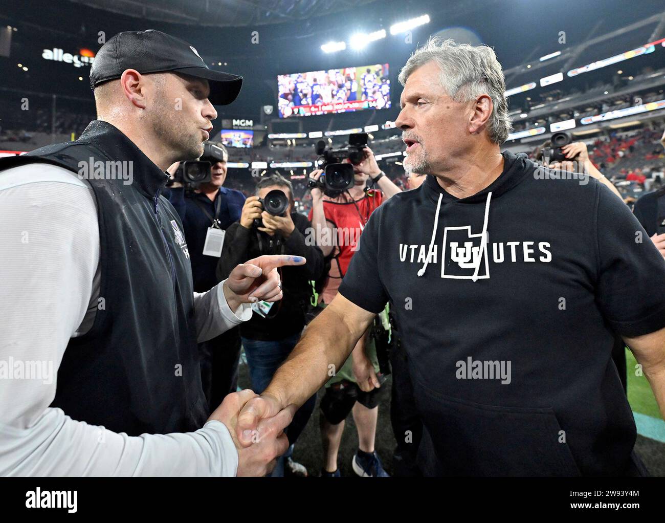 Northwestern head coach David Braun, left, and Utah head coach Kyle ...
