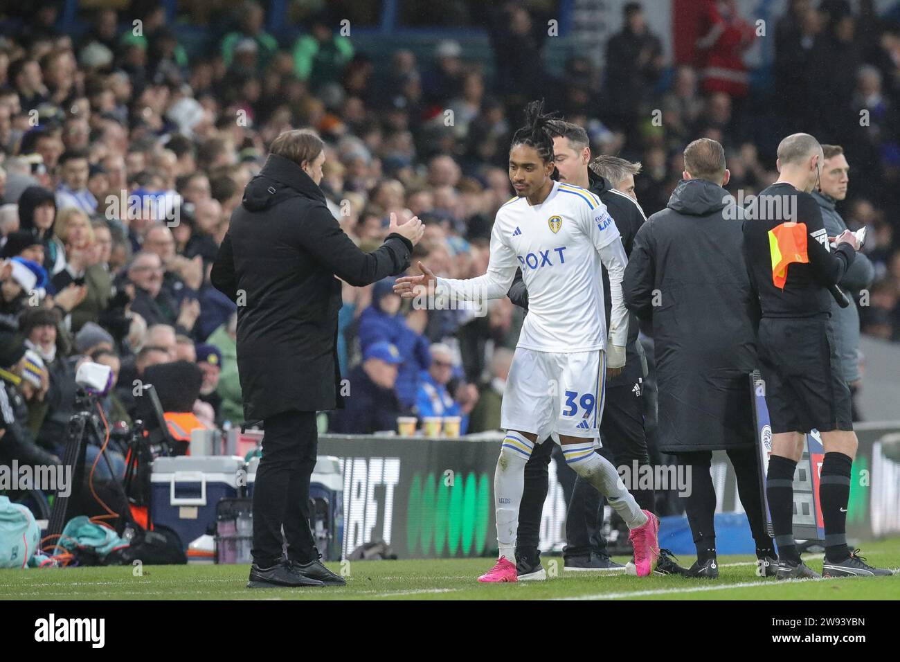Djed Spence #39 of Leeds United shakes hands with Daniel Farke manager of Leeds United in the ...
