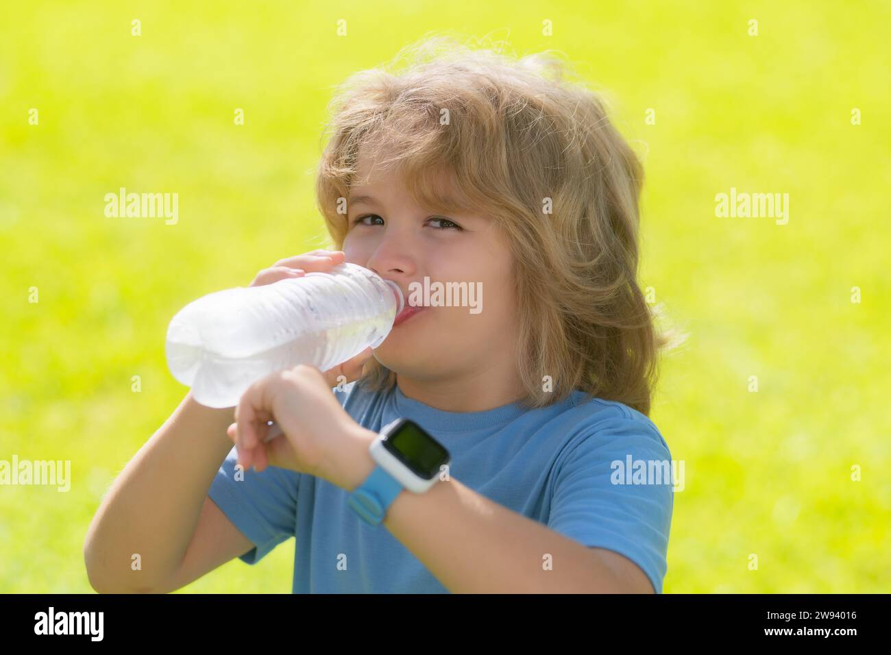 Kid drinking water. Portrait of happy smiling little child with glass ...