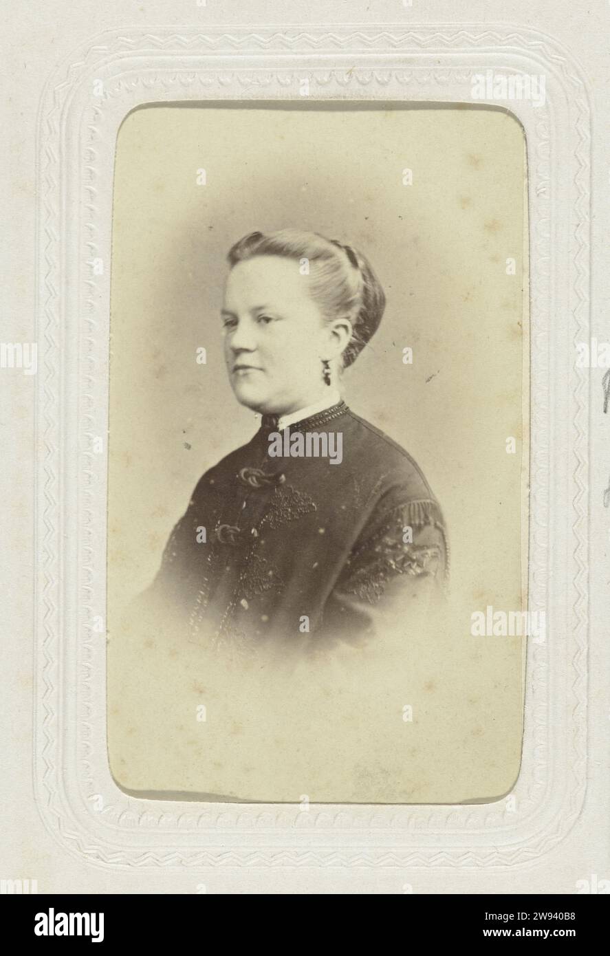 Studio portrait of a woman in traditional costume with a black cap on ...