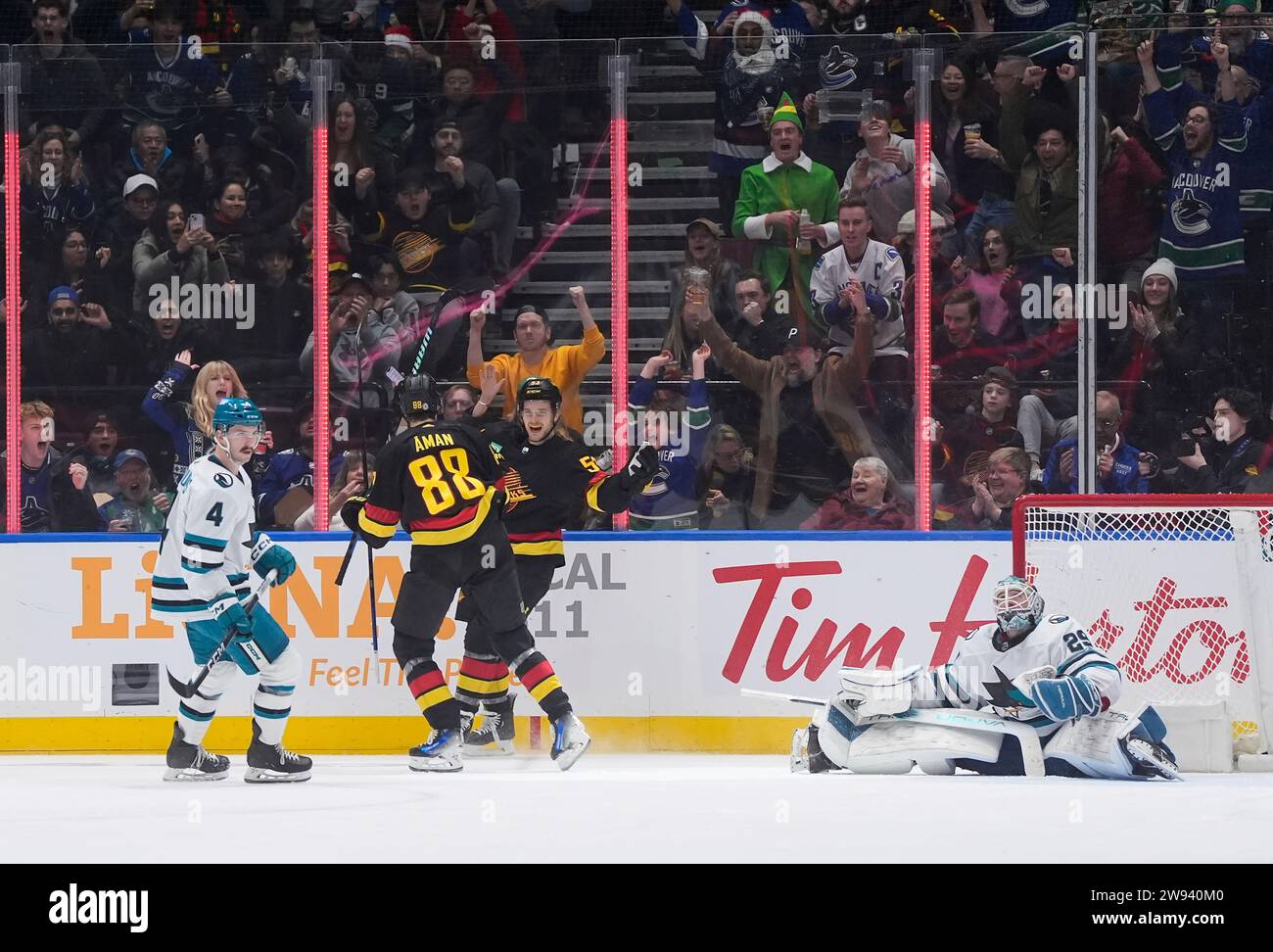 Vancouver Canucks' Teddy Blueger, back, and Nils Aman (88) celebrate ...