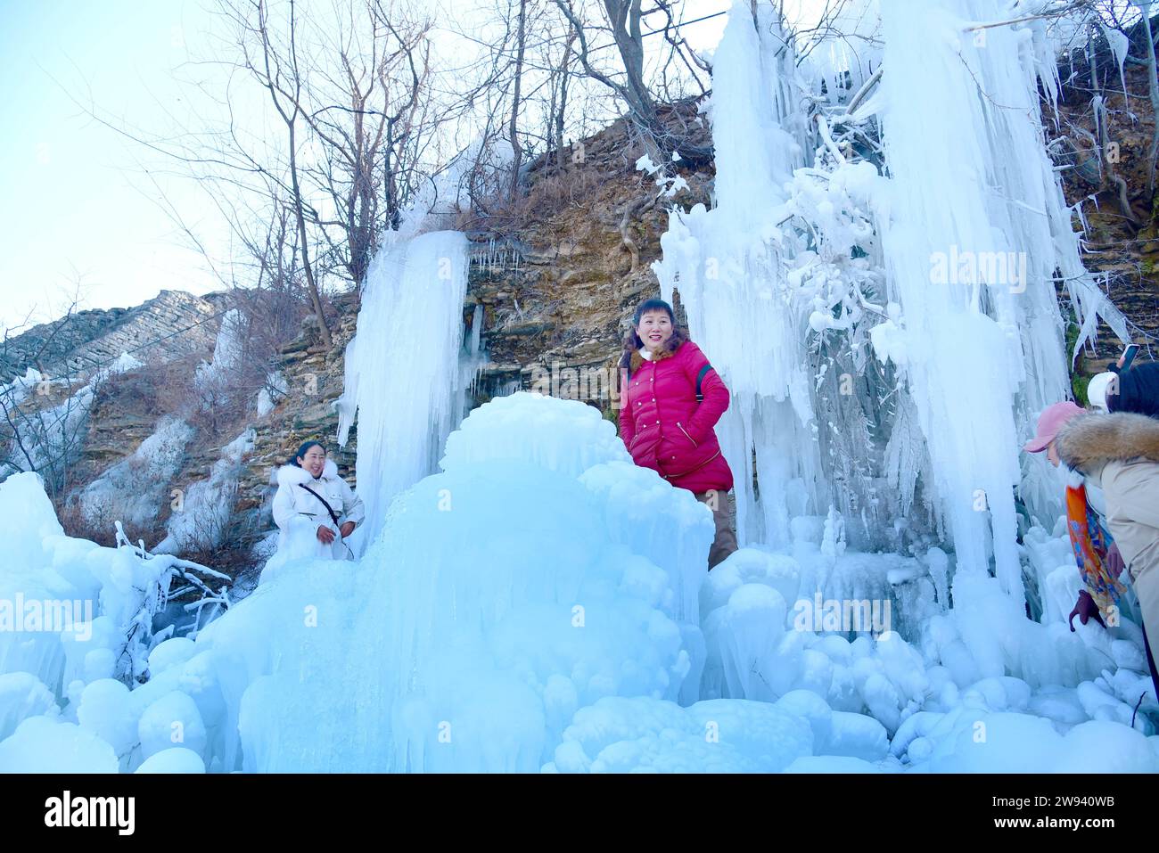 ZAOZHUANG, CHINA - DECEMBER 24, 2023 - Tourists view an icefall at Yandi village in Shanting ...