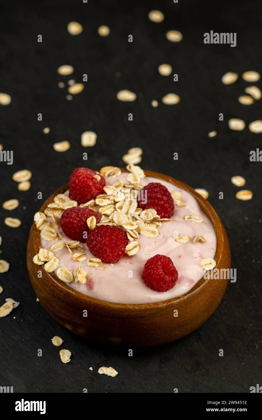fresh yogurt with raspberry flavor and oat flakes , milk yogurt with ...