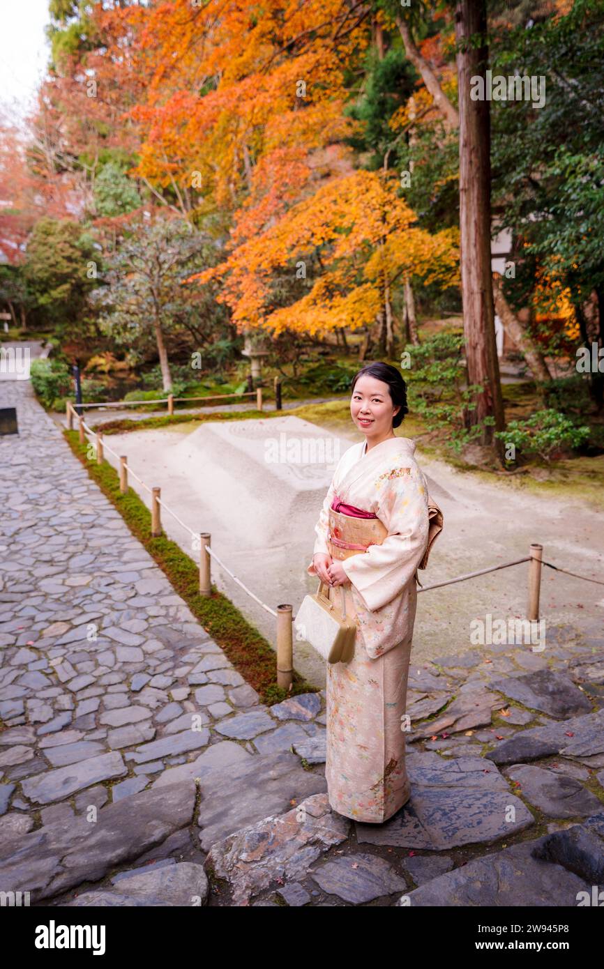 Kyoto, Japan. Woman wearing kimono in Honen-in Temple fall foliage ...