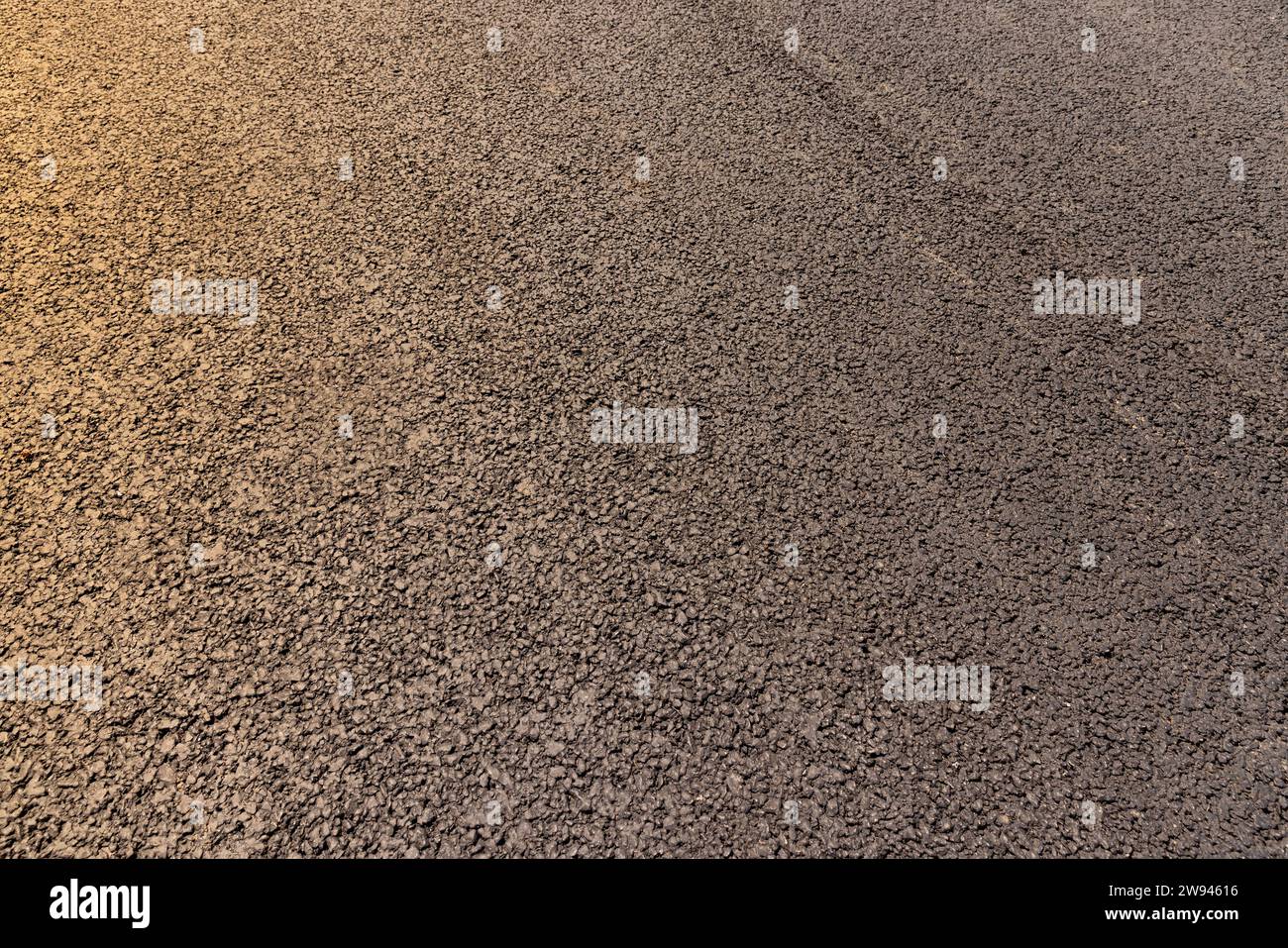 asphalting a new highway with black new asphalt, a close-up of a part ...