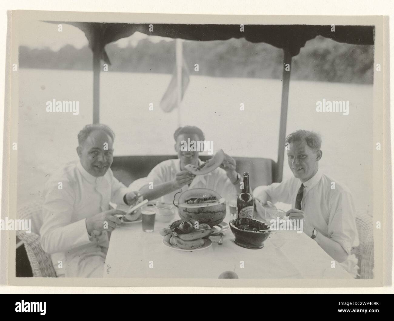 Boat trip from Paramaribo to Moengo, 1929 photograph Three men on a ...
