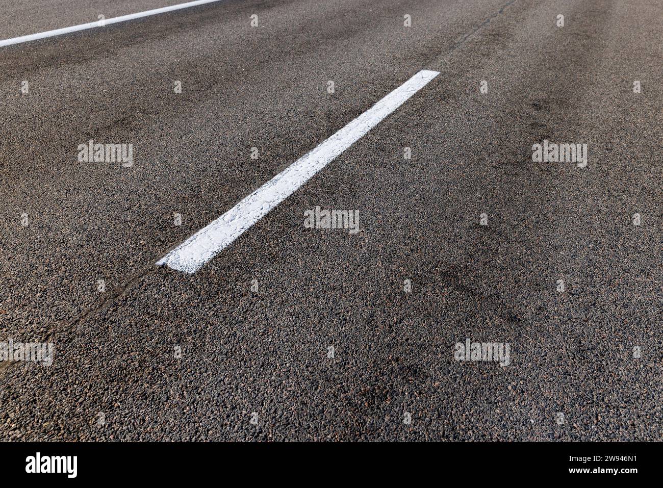 asphalting a new highway with black new asphalt, a close-up of a part ...