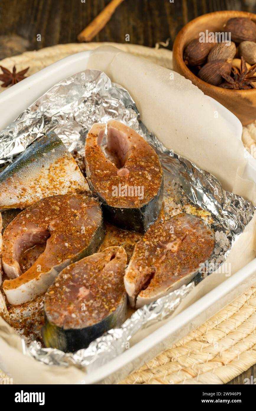 pieces of sea fish during cooking, raw yellow-tailed fish during ...